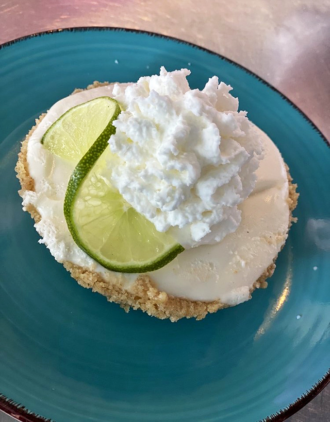 Key lime pie that strikes the perfect balance between tart and sweet. That lime slice isn't just garnish &ndash; it's a promise of authentic Florida flavor. 