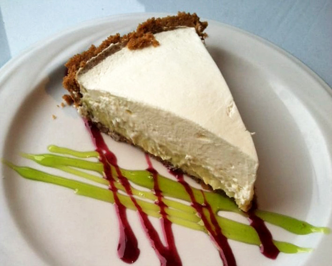Key lime pie that strikes the perfect balance between sweet and tart. That artistic drizzle isn't just for show&mdash;it's flavor choreography on a plate.
