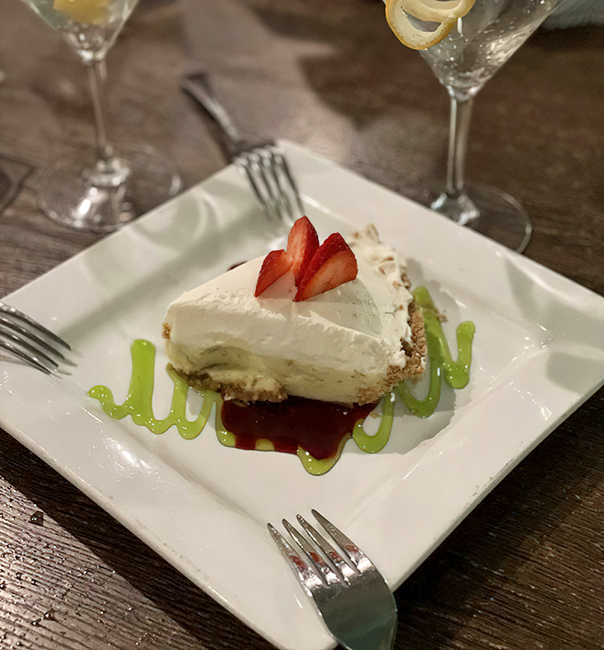 Key lime cheesecake that transports you straight to Florida's coast, complete with artistic berry garnish and lime-green sauce drizzle.
