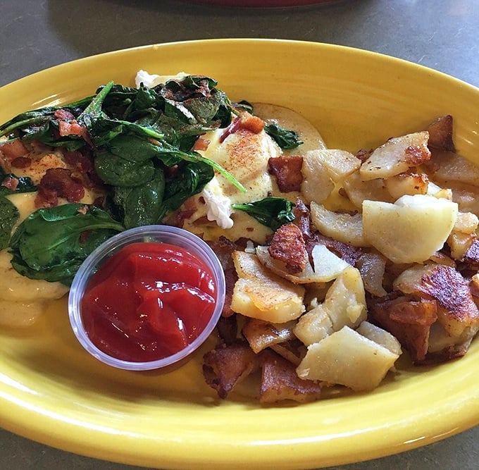 A symphony of golden potatoes, vibrant spinach, and perfectly cooked eggs. That little cup of ketchup is standing by like a loyal sidekick.