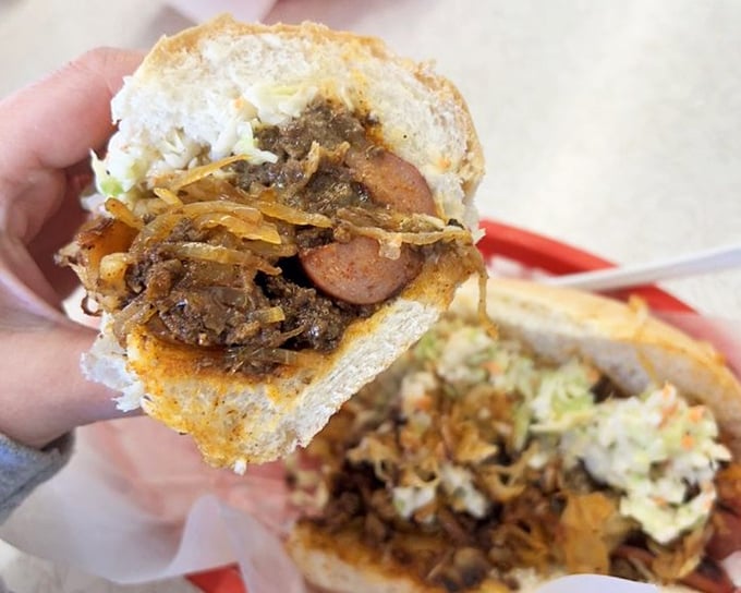 The Kitchen Sink hot dog laughs at minimalism. It's the "yes, and..." approach to toppings, where every addition creates a beautiful chaos of flavors.