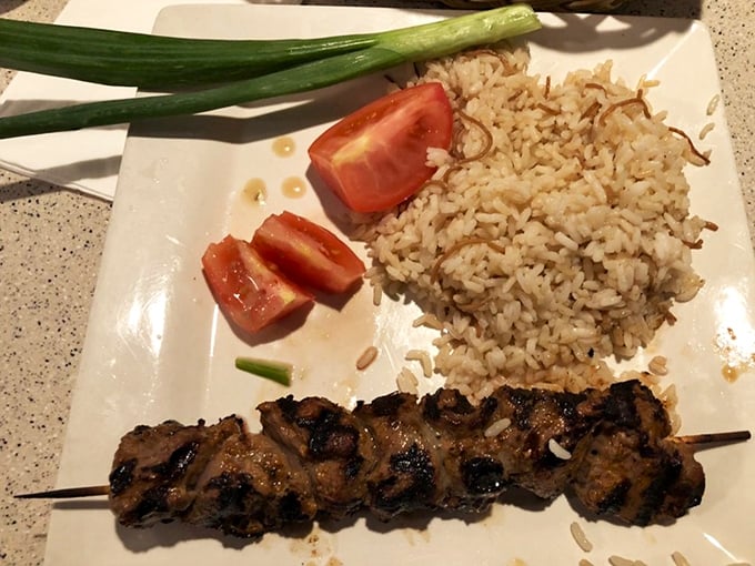 Perfectly charred lamb kebab with rice pilaf – proof that simple food done right doesn't need fancy plating or Instagram filters to be magnificent.