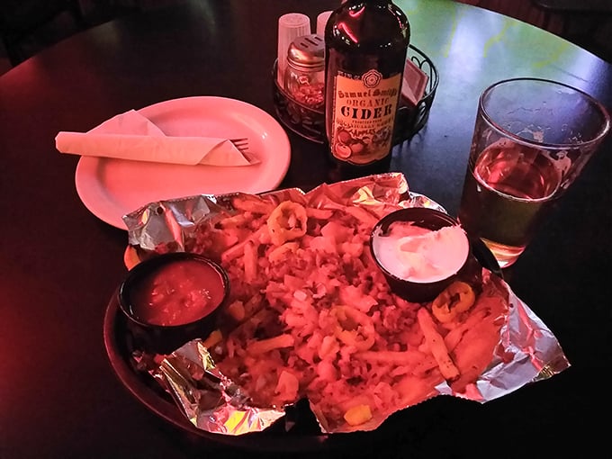 Loaded fries that laugh in the face of moderation. Pair them with that hard cider, and suddenly Monday's diet plans seem like a distant memory.