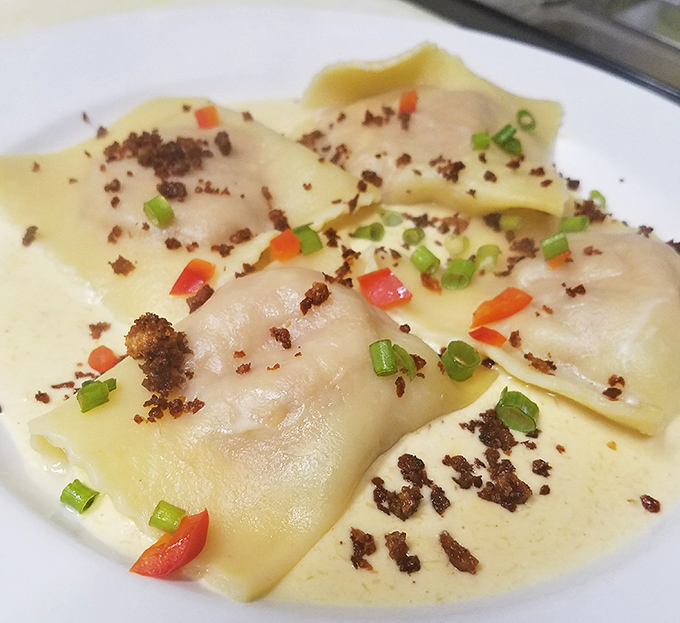 Pillows of pasta cradling lobster-infused mascarpone that would make an Italian grandmother weep with joy. The red pepper flecks add just enough heat.