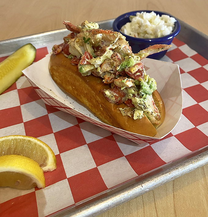 Lobster roll perfection&mdash;sweet chunks of seafood treasure nestled in a buttery vessel. That side of creamy slaw is the unsung hero of this plate.