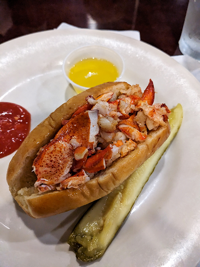 The lobster roll debate ends here&mdash;sweet meat, buttery roll, pickle spear standing guard. Simple perfection that needs no passport to impress.