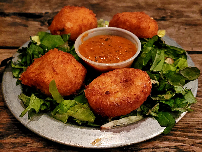 Golden-fried mac and cheese balls that crunch like your childhood dreams, served with a sauce that makes you want to high-five strangers.