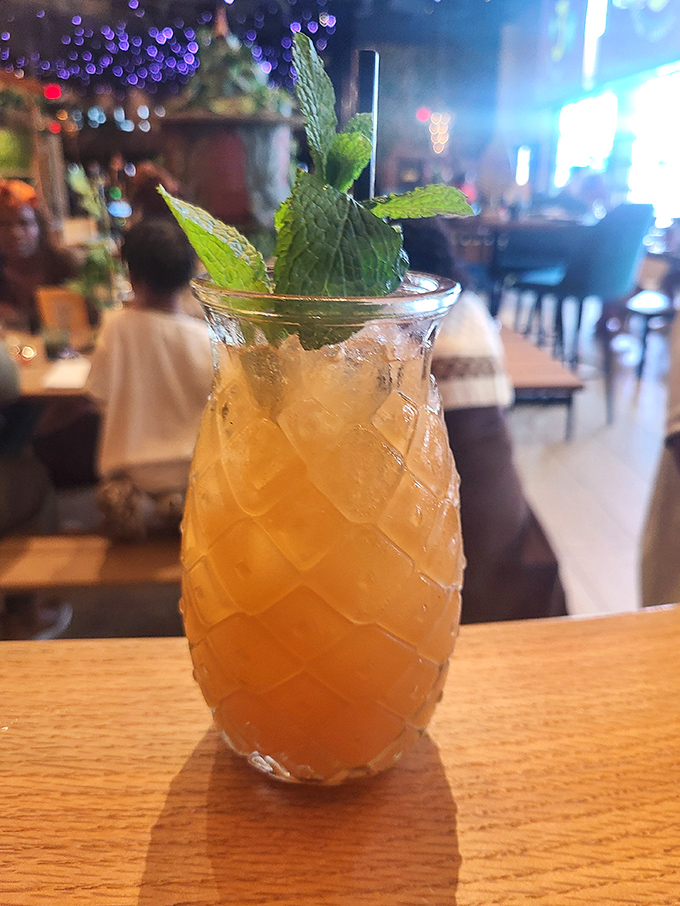 A cocktail that's dressed better than most people at the party. Fresh mint crowns this tropical concoction served in a glass that screams "vacation vibes."