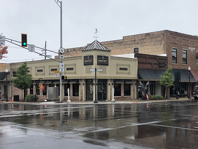 Rain-slicked streets reflect the storefronts of Main Street, where local businesses have stubbornly resisted the chain-store invasion sweeping through American downtowns.