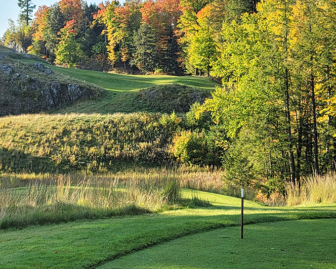 Marquette Golf Club's dramatic landscape turns a simple round into a scenic adventure, with fairways carved between rocky outcroppings and autumn-painted forests.