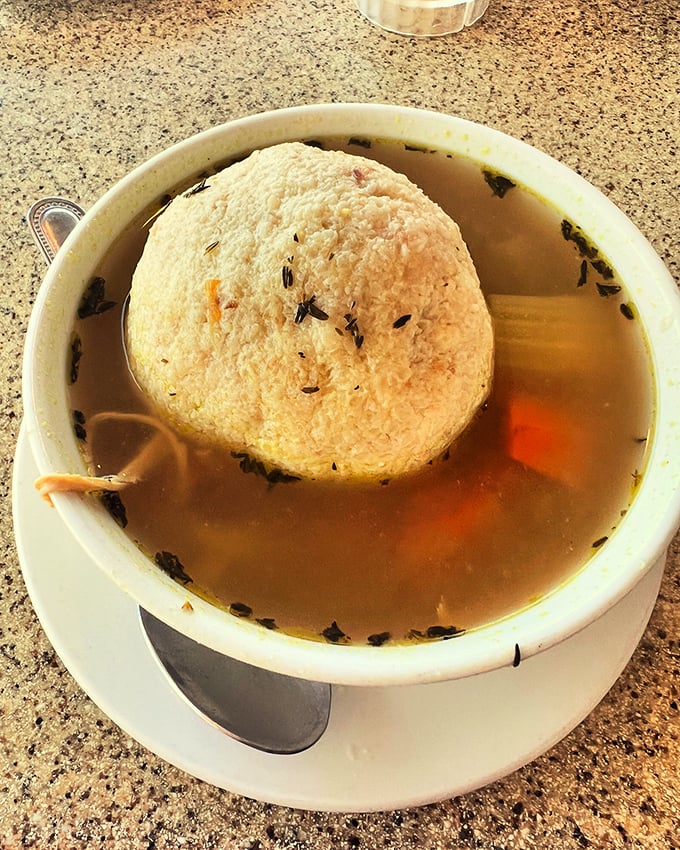The matzo ball soup&mdash;a golden broth cradling what might be the fluffiest cloud of comfort ever to float in a bowl.