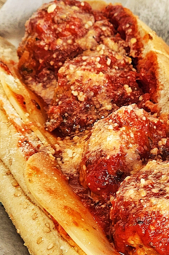 Sunday dinner transformed into handheld form &ndash; these meatballs nestled in marinara with a dusting of cheese are portable Italian grandmother love.