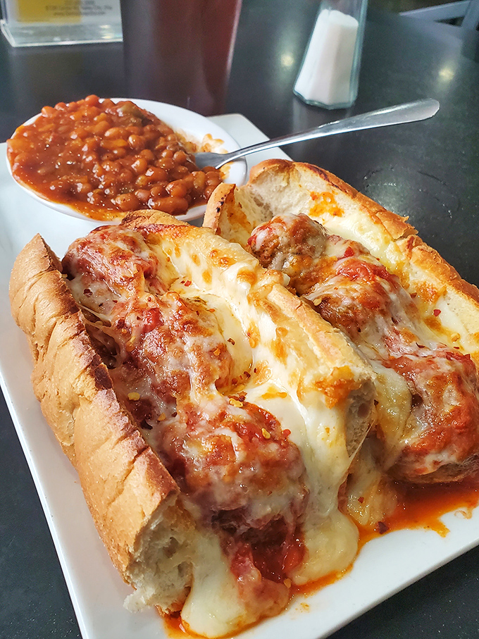 A meatball sub that demands both hands and your undivided attention. Those beans on the side aren't just playing backup&mdash;they're part of the band.