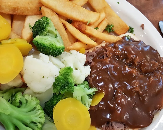 Comfort on a plate: meatloaf smothered in rich gravy alongside vegetables that somehow make you feel virtuous about the whole affair.