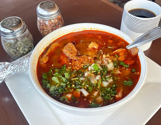 Steam rises from this menudo like a fragrant invitation. The garnishes aren't decoration&mdash;they're essential supporting actors in this soulful soup drama.