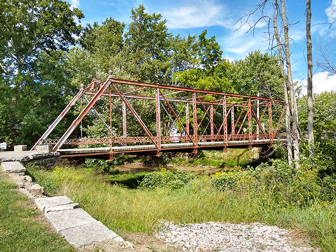 Not all bridges wear red coats. This metal companion to Roberts Bridge offers its own industrial charm, spanning the creek with steely determination.