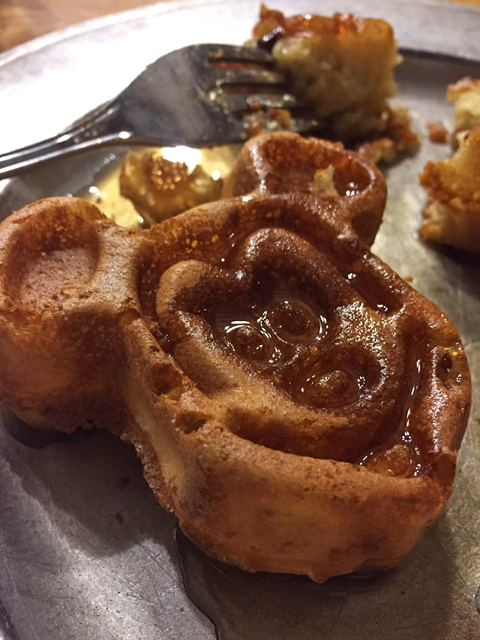 The famous Mickey waffle arrives golden and perfect, proving that mouse-shaped food always tastes better somehow.