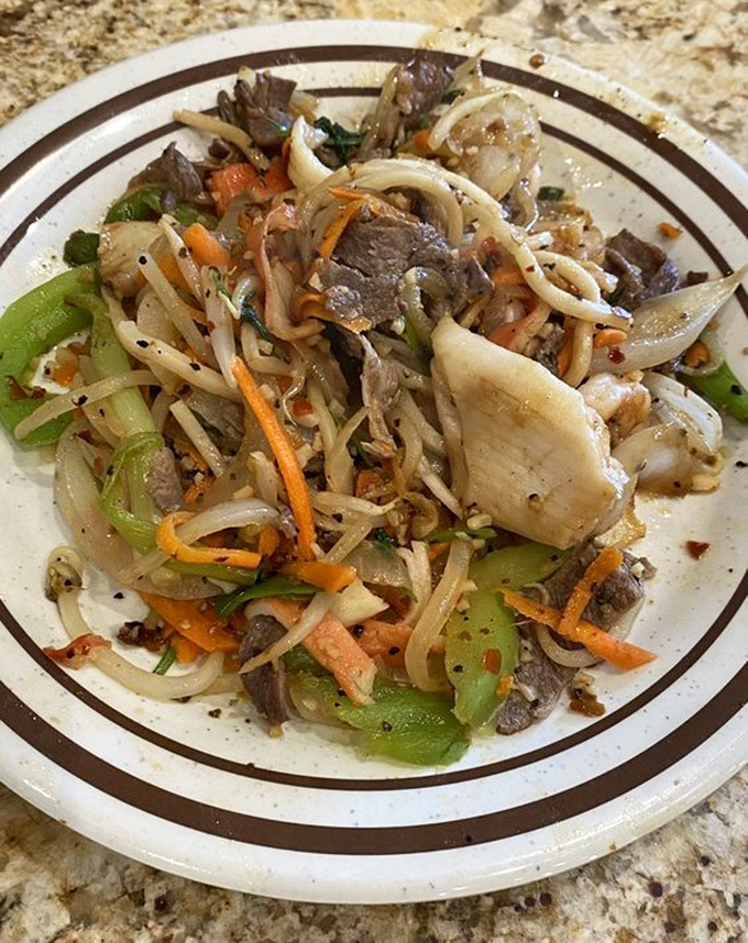 A plate that tells a story of culinary adventure &ndash; noodles, vegetables, and protein dancing together in perfect harmony.