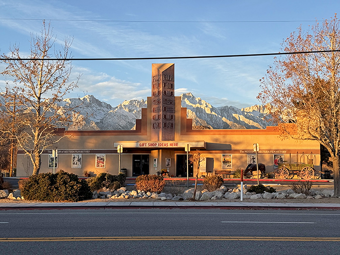 The Museum of Western Film History glows golden in late afternoon light, housing treasures from Hollywood's love affair with these rugged landscapes.