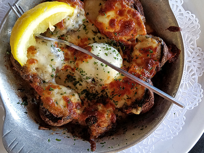 Mushrooms that have clearly been to finishing school. Broiled with cheese until bubbling, they're the fungi you actually want at your party.