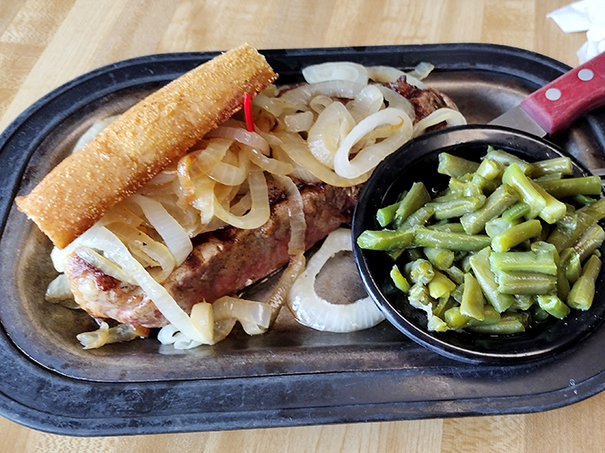 The NY Strip arrives like a meaty celebrity on its own sizzling stage, with grilled bread standing by for juice-sopping duty.