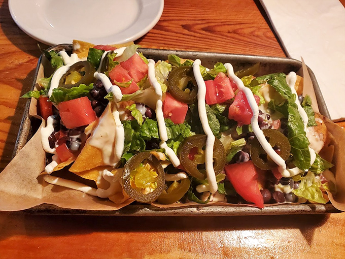 These aren't your movie theater nachos. Loaded with fresh toppings, jalapeños, and drizzled with creamy sauce – every chip a perfect little flavor platform.