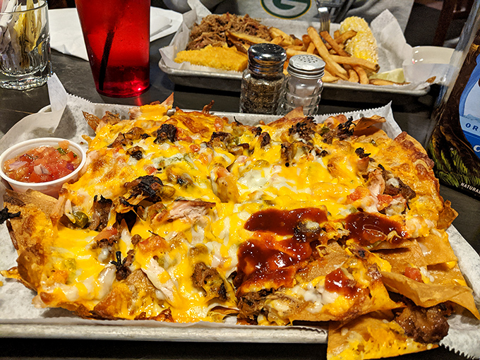BBQ nachos that render conversation impossible. When melted cheese meets smoky meat atop crispy chips, the only appropriate response is reverent silence punctuated by happy crunching.