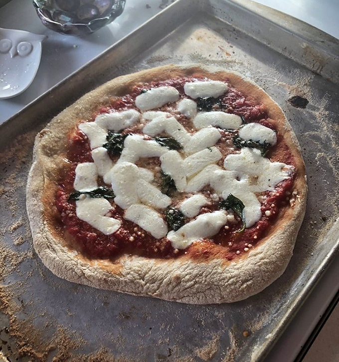A perfect Neapolitan pizza emerging from the oven—that leopard-spotted crust is the culinary equivalent of finding a four-leaf clover. Pure good fortune on a pan.