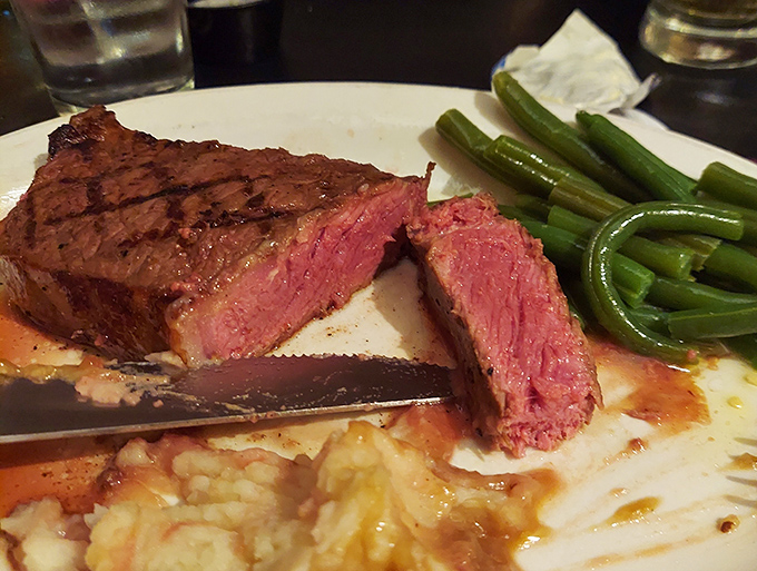 The New York Strip, cooked to a textbook medium-rare, rests beside green beans and risotto—a trio that belongs together like The Three Tenors.