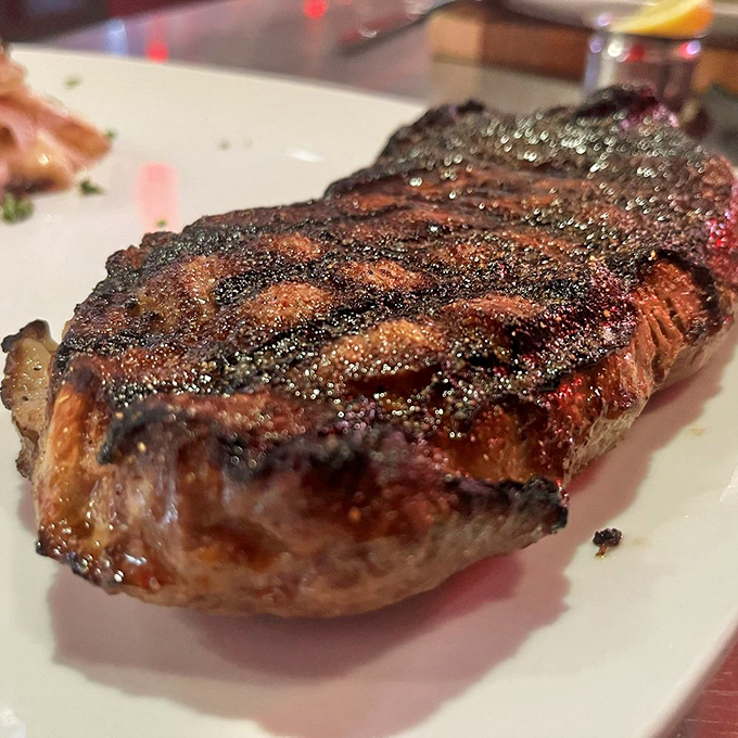 A perfectly seared New York strip displaying those coveted grill marks that say, "The chef knows exactly what they're doing." Meat masterpiece, indeed.