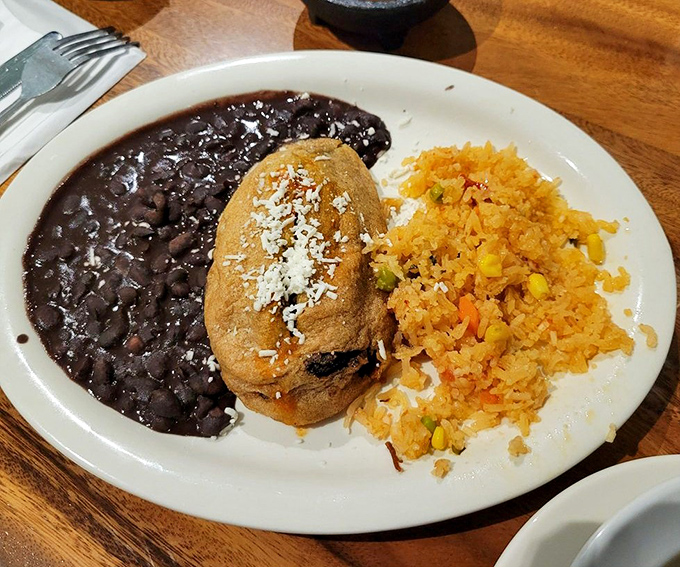 This chile relleno isn't just stuffed&mdash;it's living its best life under a blanket of sauce with beans that didn't come from a can.