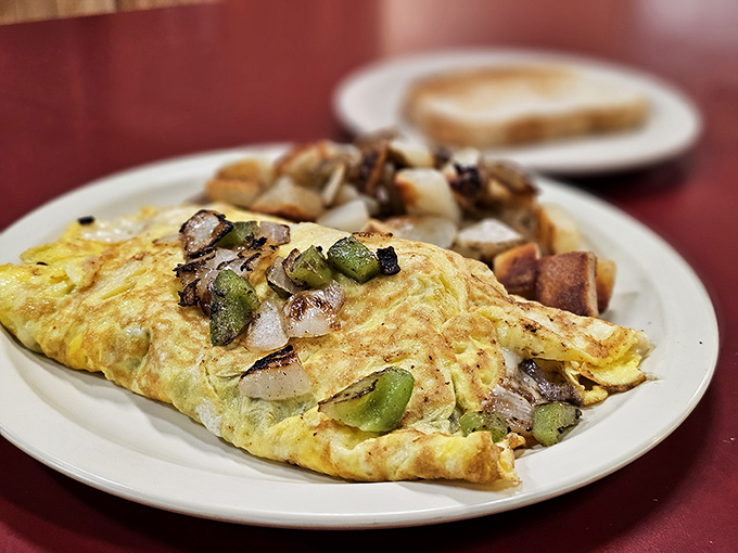 This isn't one of those dainty "California omelets" with microgreens. It's a proper Midwest creation—substantial, generous, and unapologetically delicious.