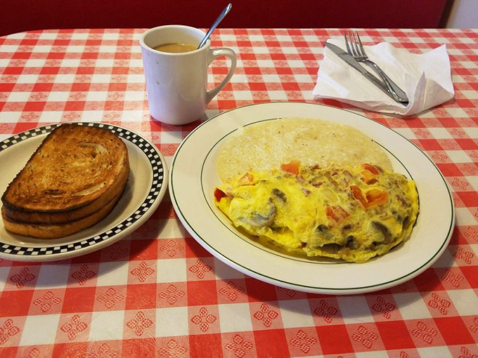 Morning masterpiece alert! A fluffy omelet packed with veggies alongside perfectly golden toast &ndash; the breakfast equivalent of hitting all green lights on your morning commute.