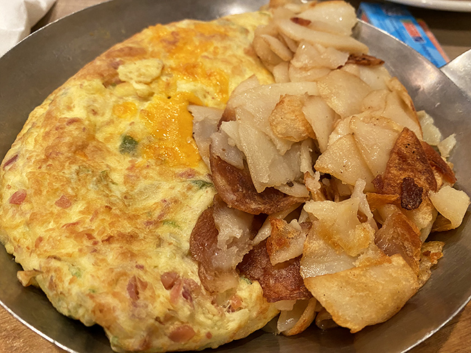 This isn't just an omelet&mdash;it's a perfect golden envelope delivering a message of breakfast joy, with hash browns that deserve their own fan club.