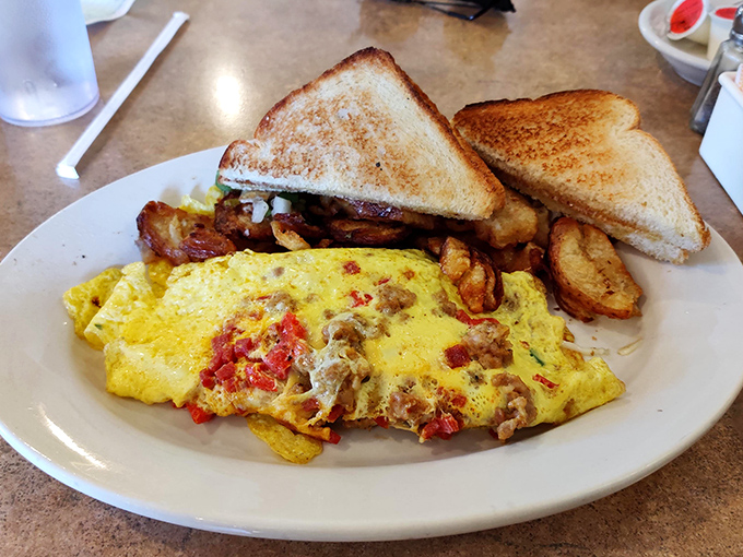 This isn't just breakfast, it's morning therapy&mdash;a fluffy omelet studded with savory fillings, home fries that crackle with each bite, and toast ready for butter's embrace.
