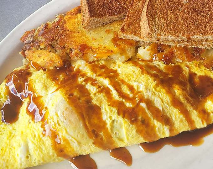 Sunshine on a plate! This golden omelet drizzled with gravy proves that breakfast foods are too important to be limited to morning hours.