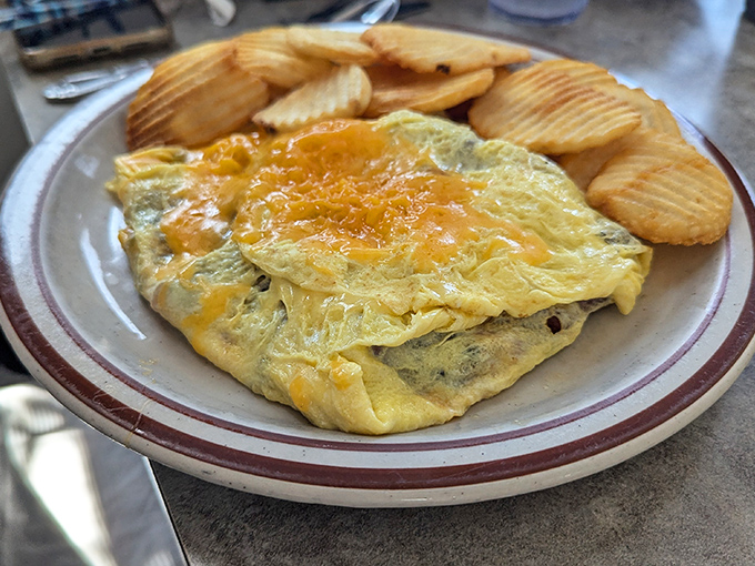 This cheese-blanketed omelet with crispy potatoes is the breakfast equivalent of a warm hug. Comfort food that speaks a universal language.