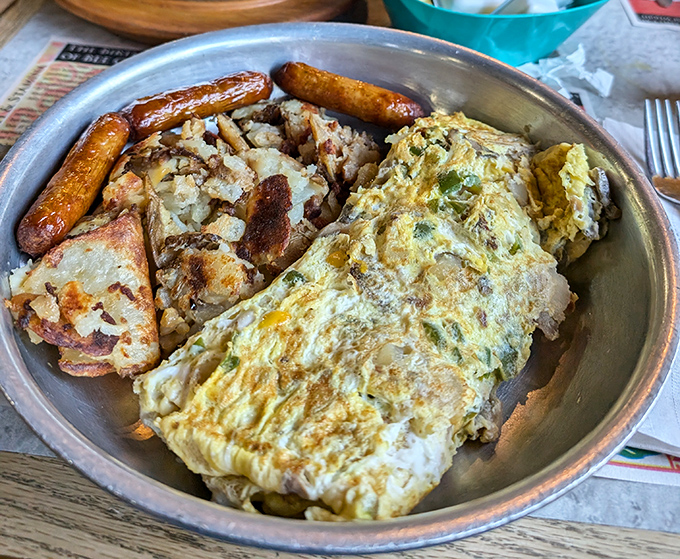 This isn't just an omelet—it's a masterclass in breakfast architecture, with perfectly diced vegetables and cheese melted just right.