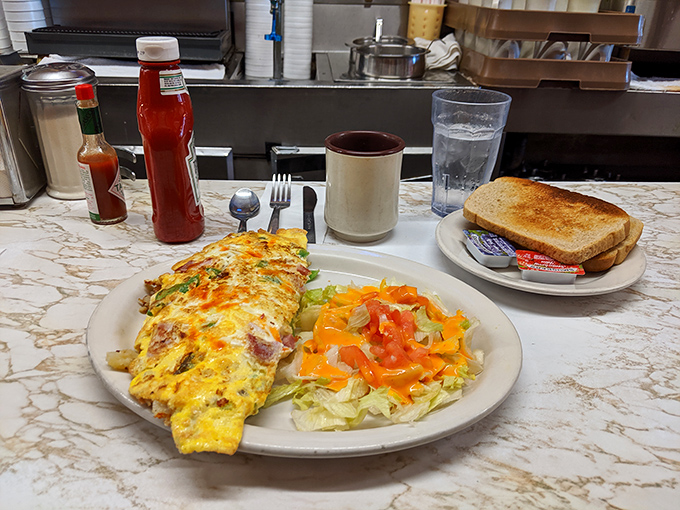 Breakfast perfection doesn't need fancy plating. This omelet, salad, and toast trio is the working person's power meal.
