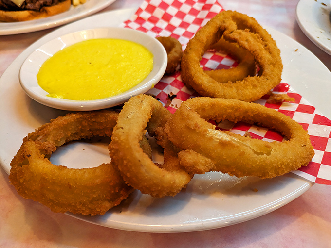Golden halos of crispy perfection. These onion rings aren't side dishes; they're main events that generously share the spotlight.