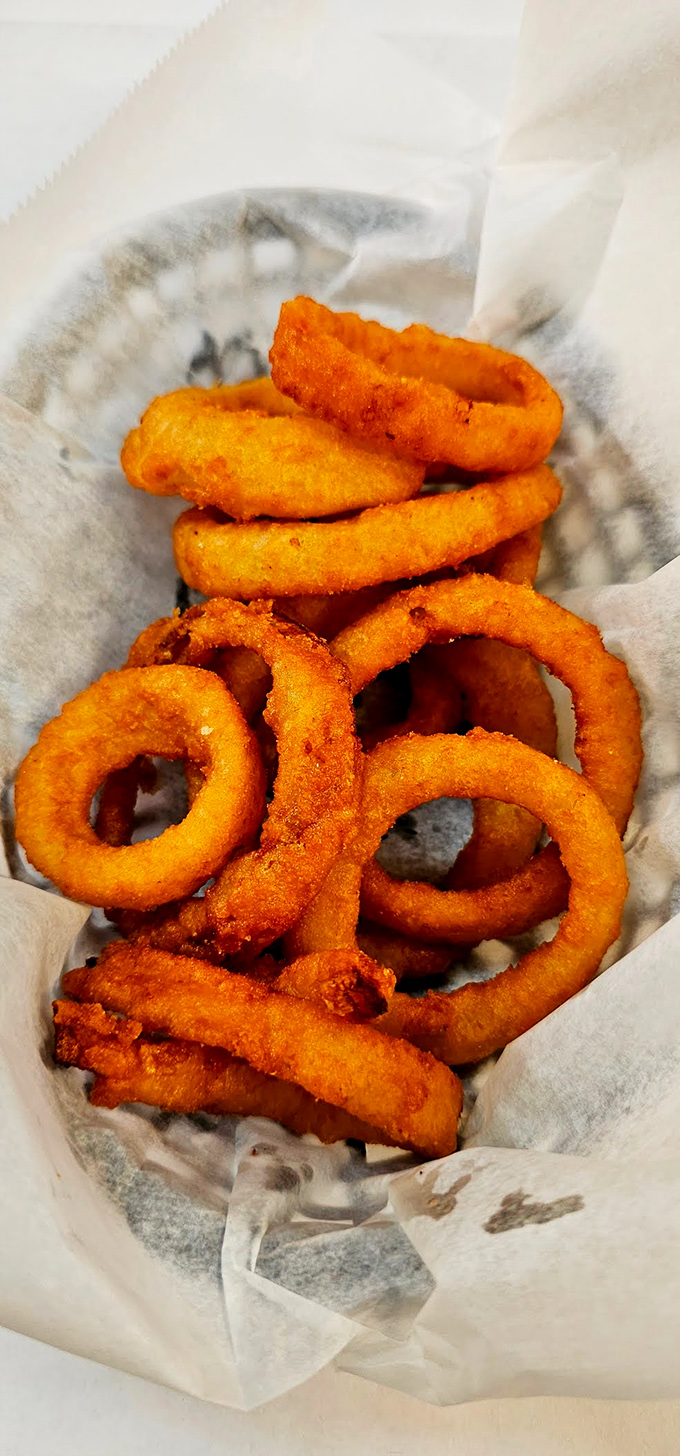 Golden rings of happiness stacked like delicious life preservers. The kind of onion rings that make you forget you're eating a vegetable.