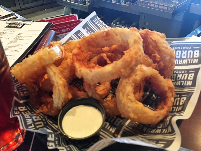 Onion rings stacked higher than your weekend ambitions, with a batter-to-onion ratio that would make mathematicians weep with joy.