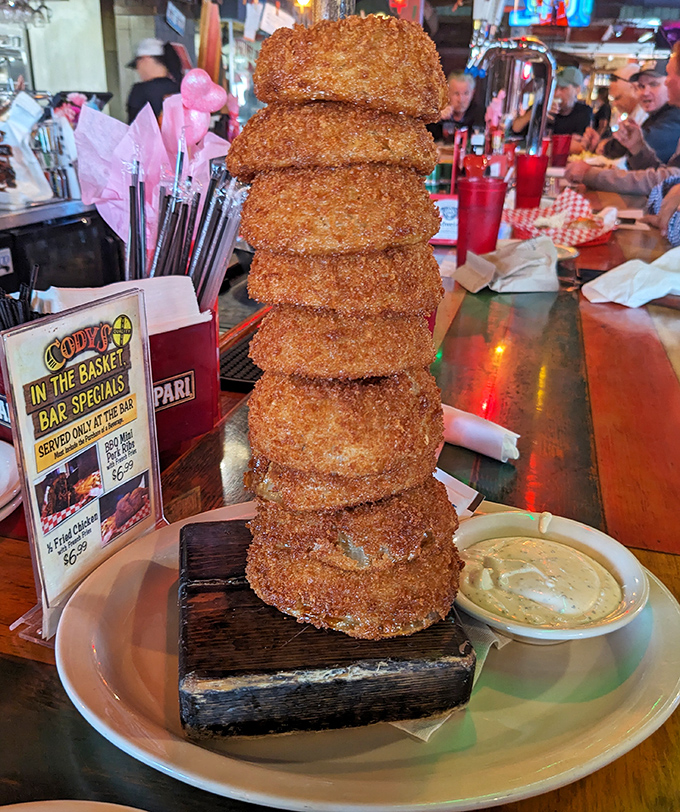 The leaning tower of onion rings&mdash;architectural marvel meets deep-fried perfection. Whoever said "less is more" clearly never experienced this golden-brown monument to excess.