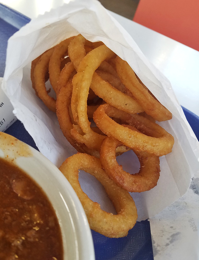 Golden, crispy onion rings that crackle with each bite &ndash; the perfect supporting actor to the chili's starring role in this Findlay food drama.