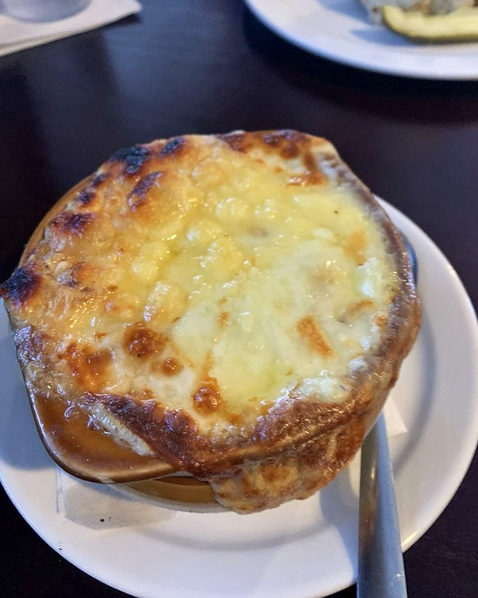 Bubbling cheese creates a golden canopy over this French onion soup&mdash;a bowl that understands sometimes the best things in life require a spoon.