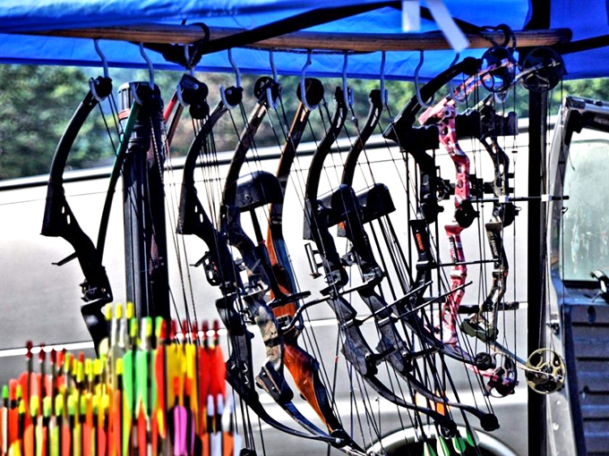 Weekend warriors' paradise. These compound bows hang like sleeping predators, ready for their next adventure in Pennsylvania's woods.