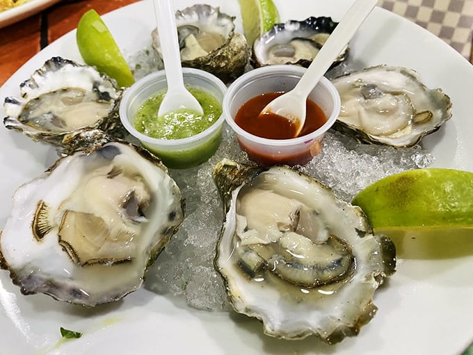 Fresh oysters on ice with lime wedges and dipping sauces&mdash;nature's perfect appetizer, just waiting for a squeeze and a slurp.