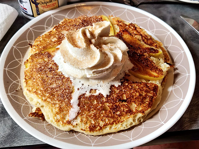 Pancake poetry in motion&mdash;golden, crispy edges giving way to fluffy centers, crowned with a cloud of whipped cream. Breakfast doesn't get more photogenic than this.