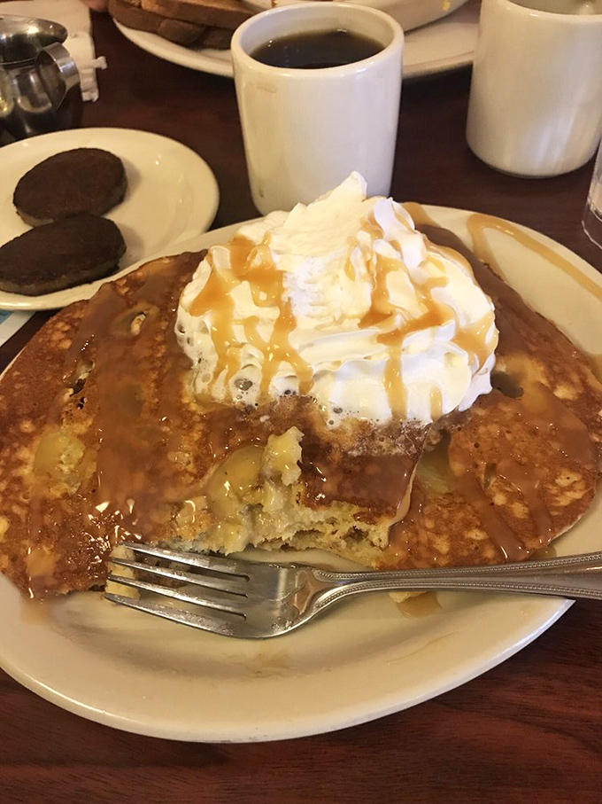 Pancake perfection with a crown of whipped cream and caramel drizzle. This isn't just breakfast&mdash;it's therapy on a plate.