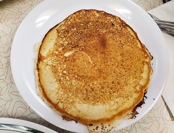 This pancake doesn't just hang over the edge of the plate&mdash;it's staging a full-blown territorial expansion.